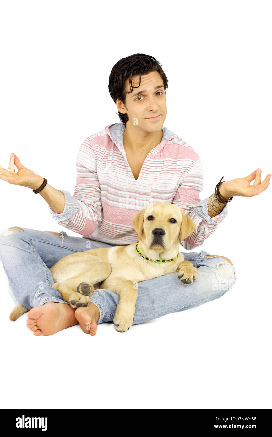 Young man with puppy labrador dog playing yoga position Stock Photo - Alamy