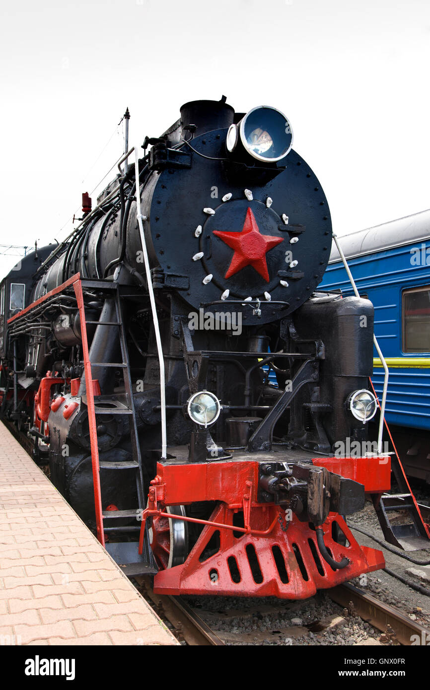 Old steam train is leaving a station Stock Photo - Alamy