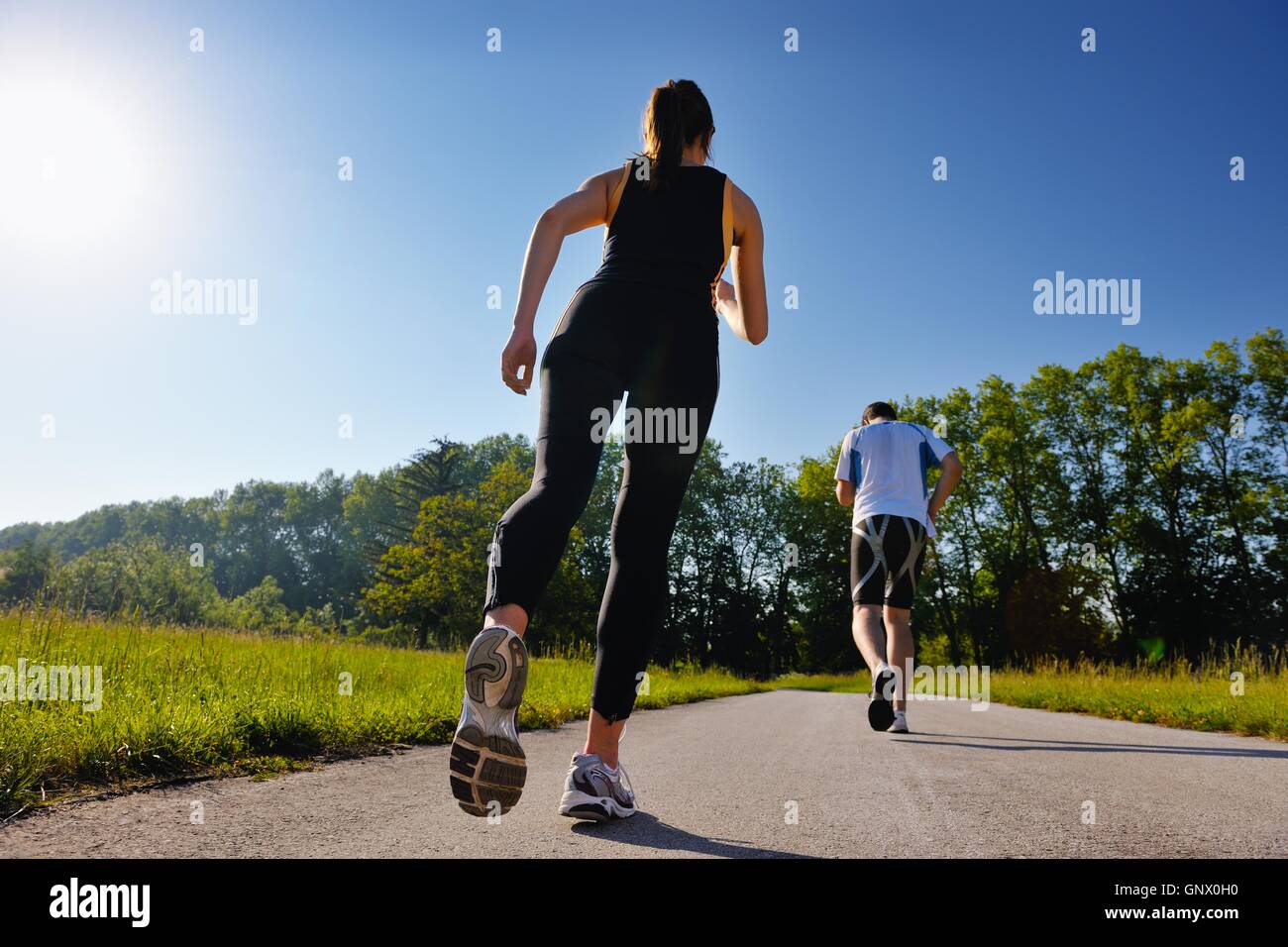 Young couple jogging Stock Photo - Alamy