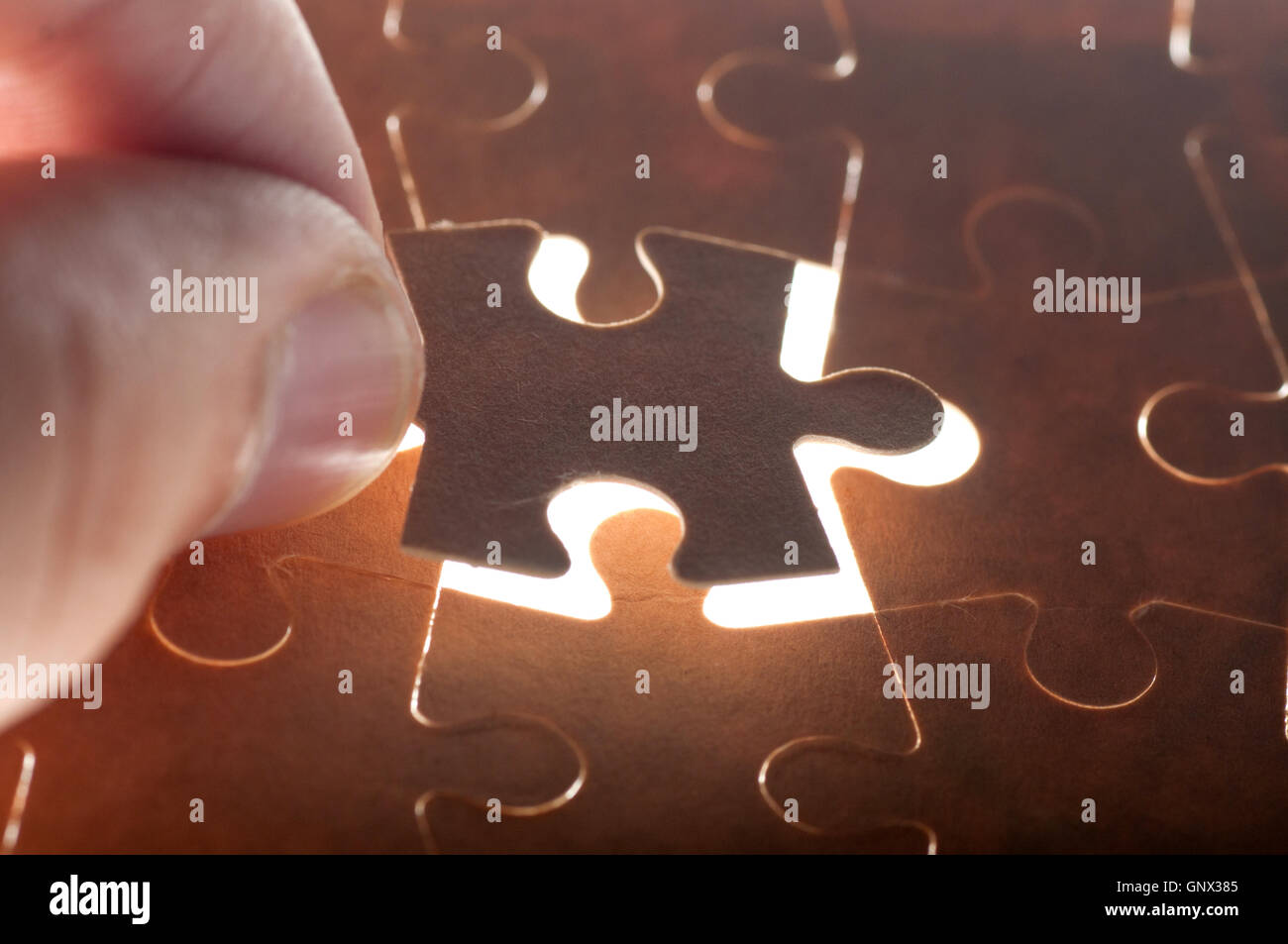 hand holding puzzle piece close up Stock Photo - Alamy