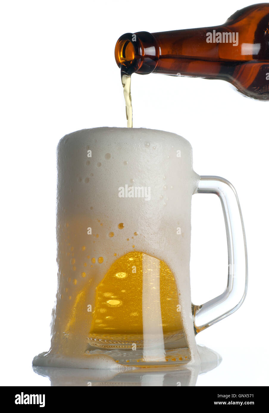 Beer is Pouring into mug on white Stock Photo - Alamy