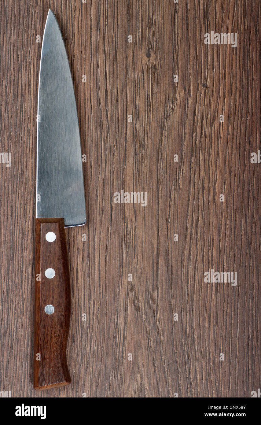Knife on rustic kitchen table with space Stock Photo - Alamy