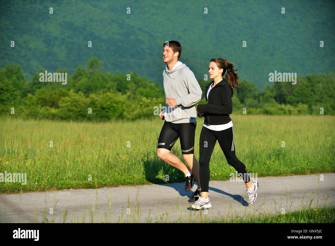 Young couple jogging Stock Photo - Alamy