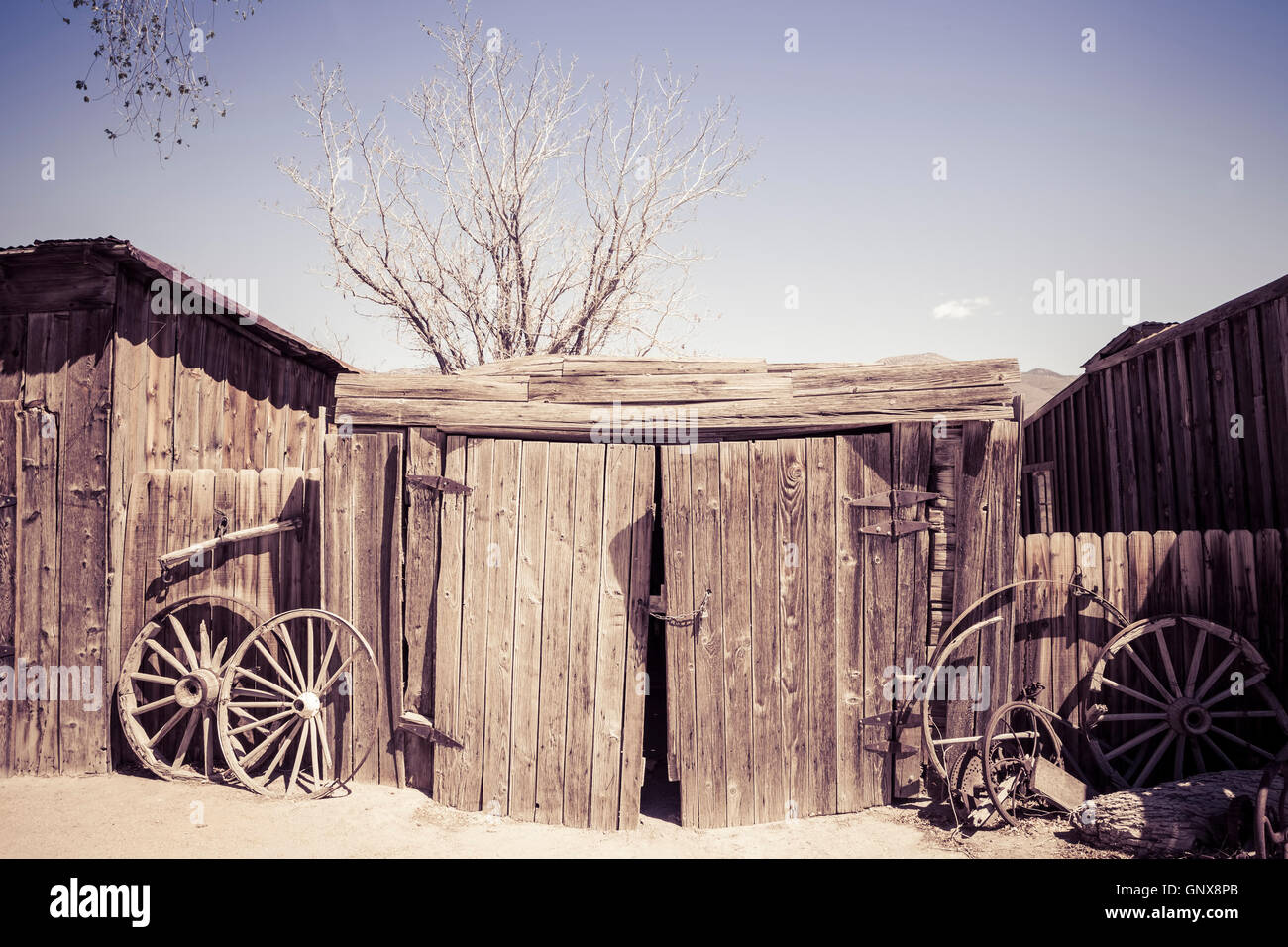 Rustic old western garage with wagon wheels processed with vintage ...