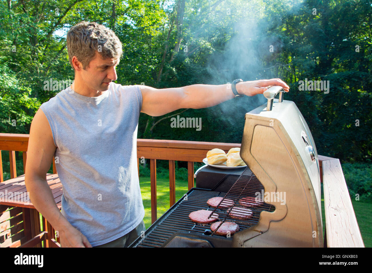 Man cooking on the grill outside Stock Photo - Alamy