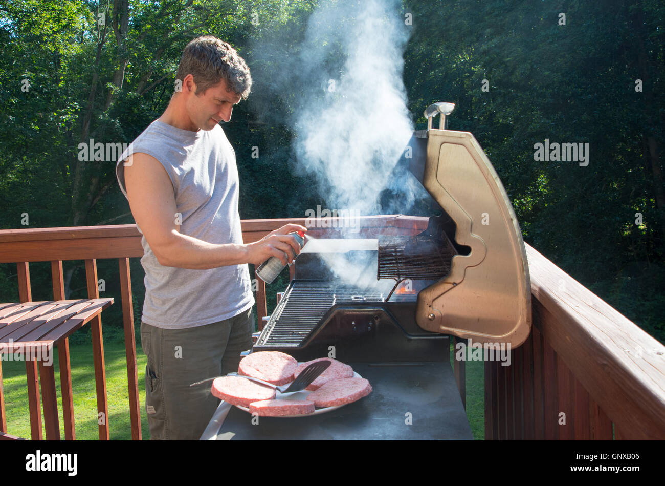 Man cooking on the grill outside Stock Photo - Alamy