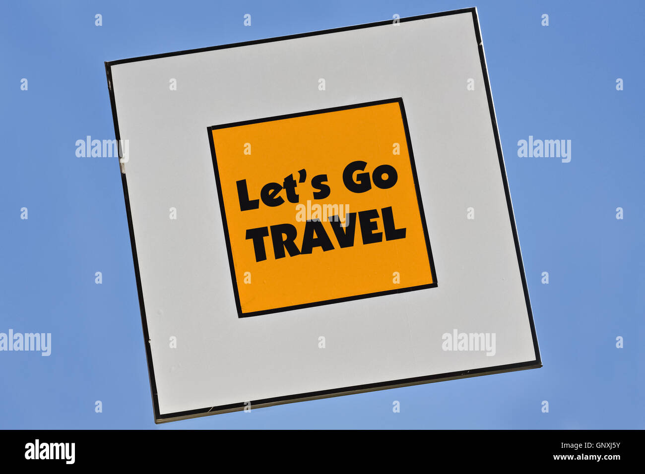 Text Lets Go Travel written on yellow road sign Stock Photo - Alamy