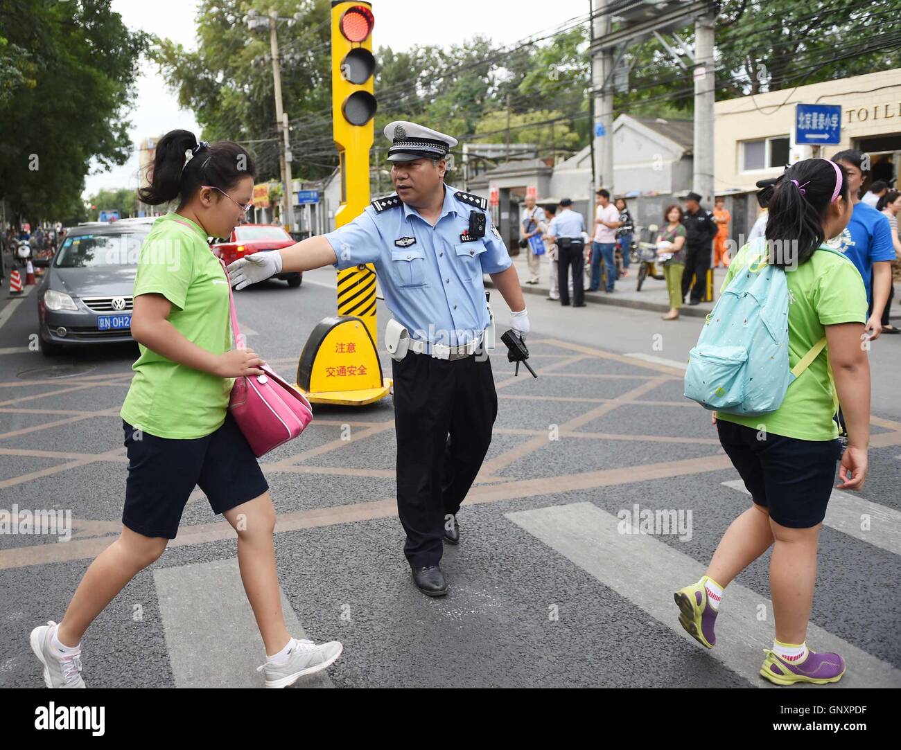 Beijing, China. 1st Sep, 2016. Students walk across a crosswalk in ...