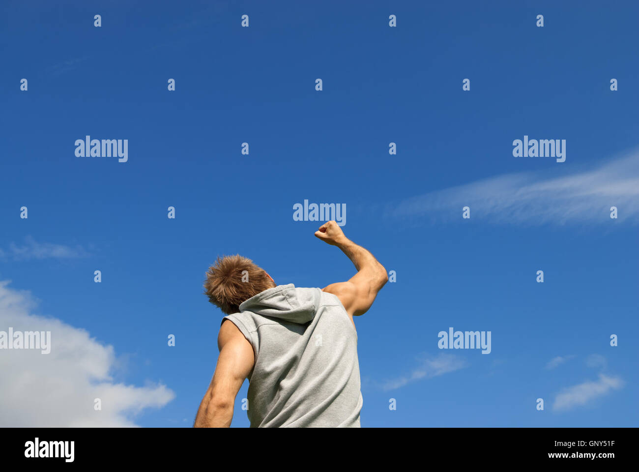 Back view man raised fist hi-res stock photography and images - Alamy