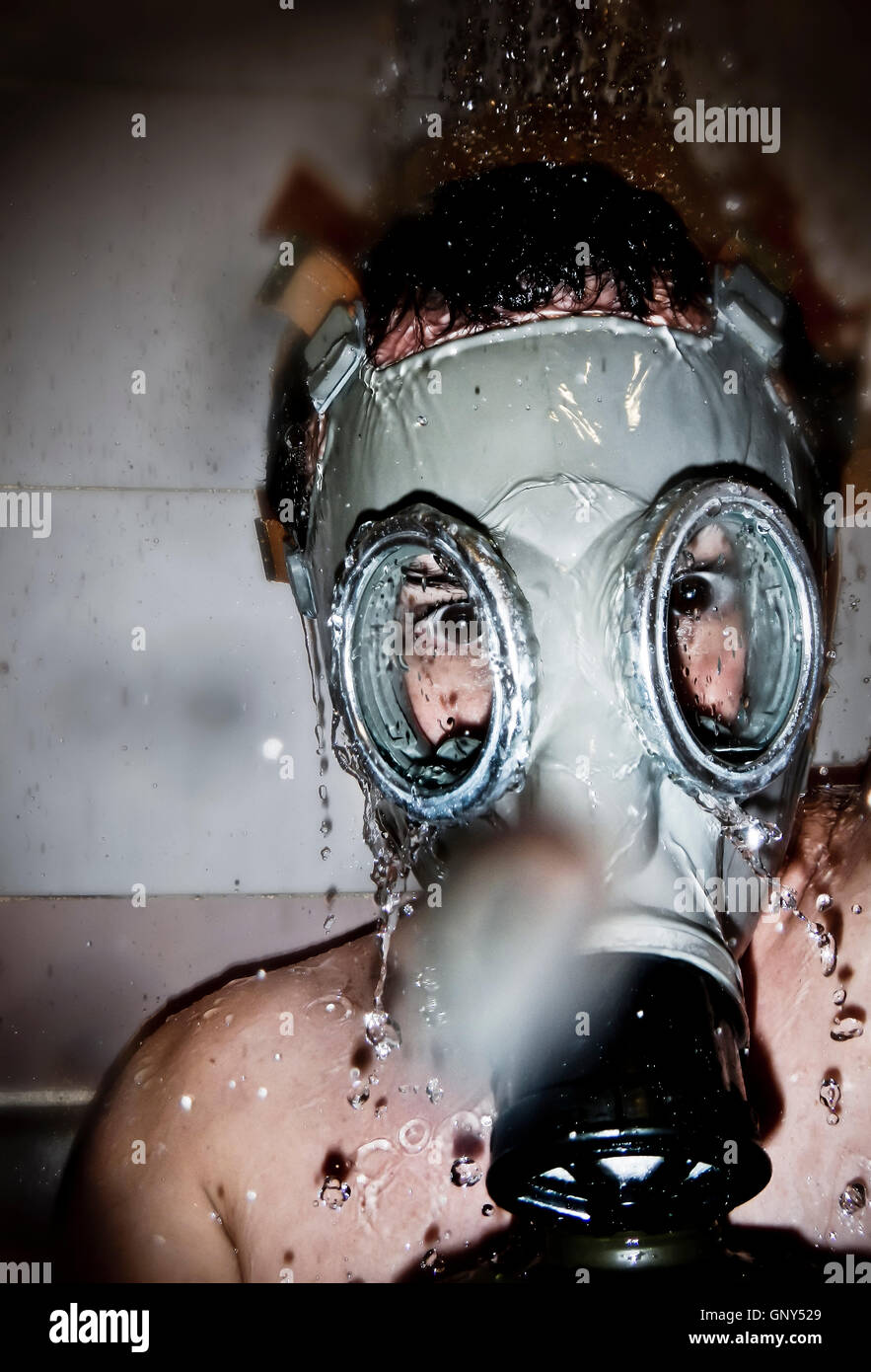 Man in gas mask with water reflection in the eyes over artistic Stock ...