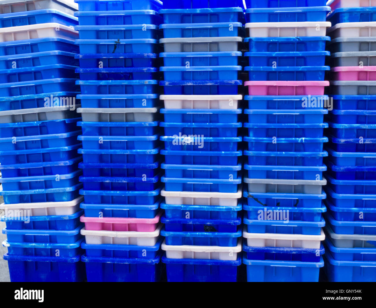Stack of empty colorful plastic fishery containers Stock Photo - Alamy