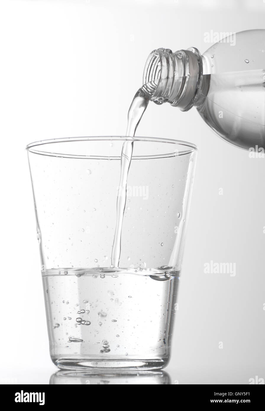 Water poured into glass, isolated on white Stock Photo - Alamy