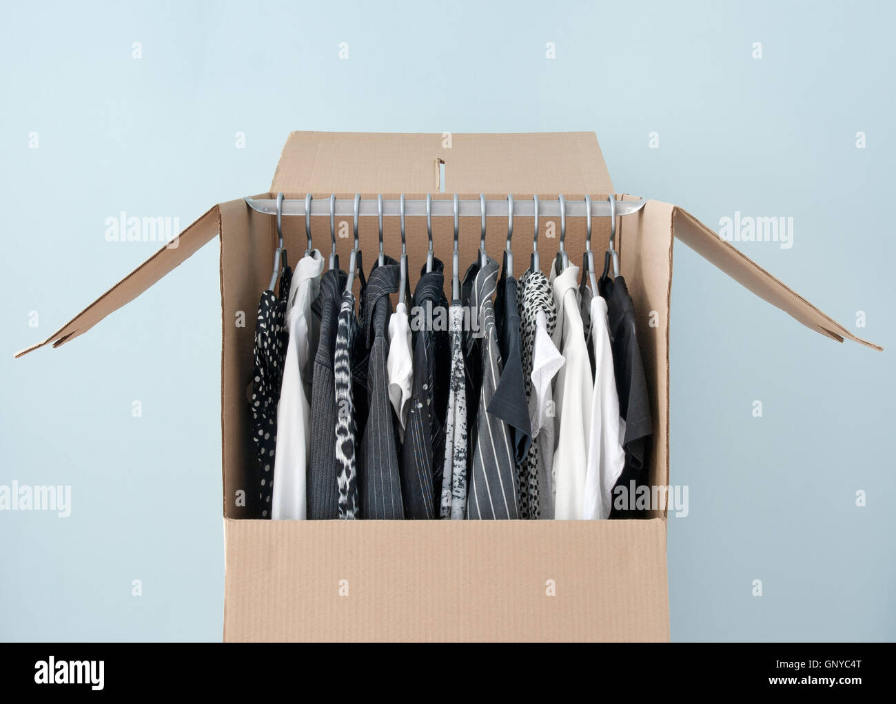 Clothes in a wardrobe box for easy moving Stock Photo - Alamy