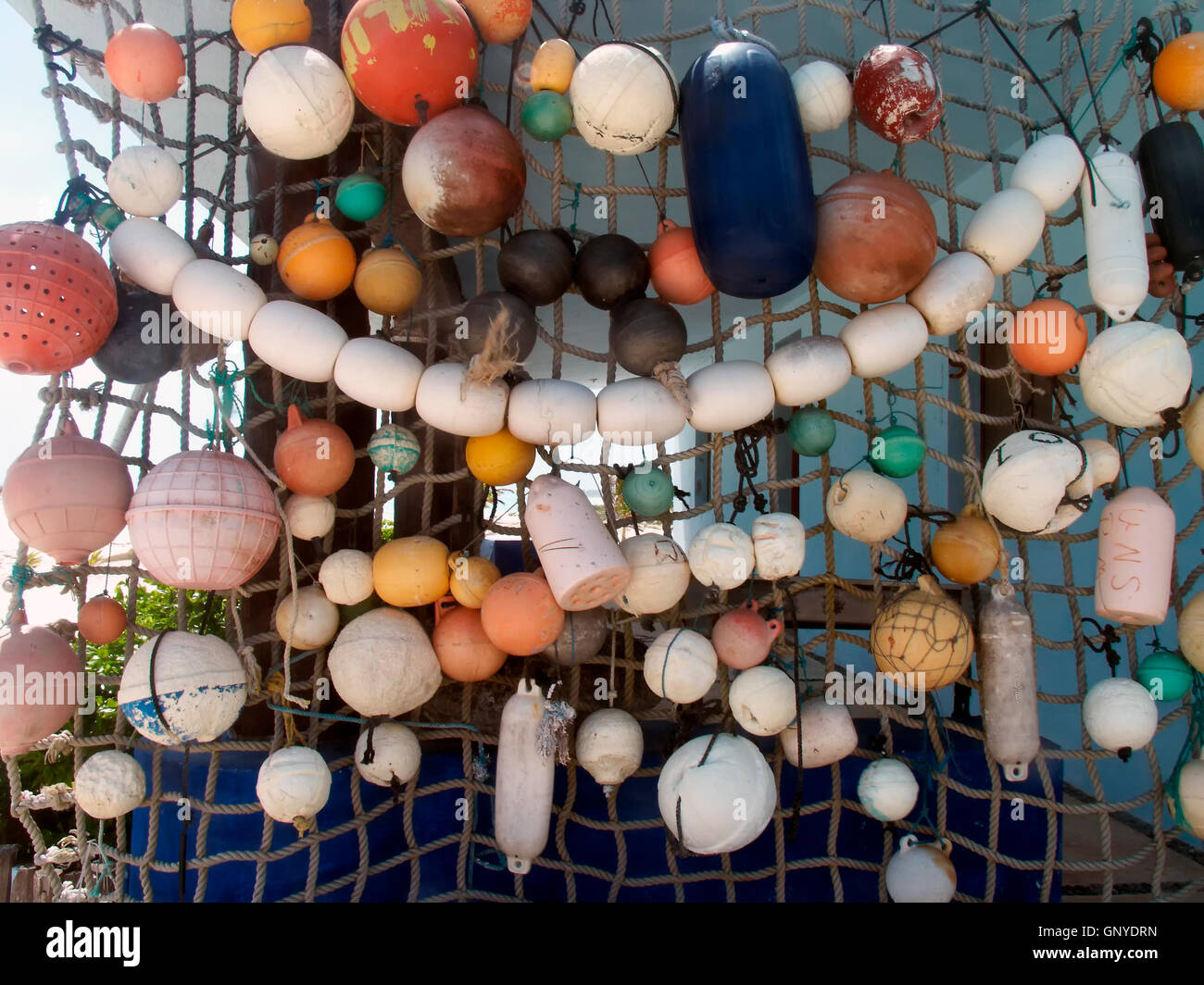 Colorful fishnet floats on the caribbean beach Stock Photo - Alamy