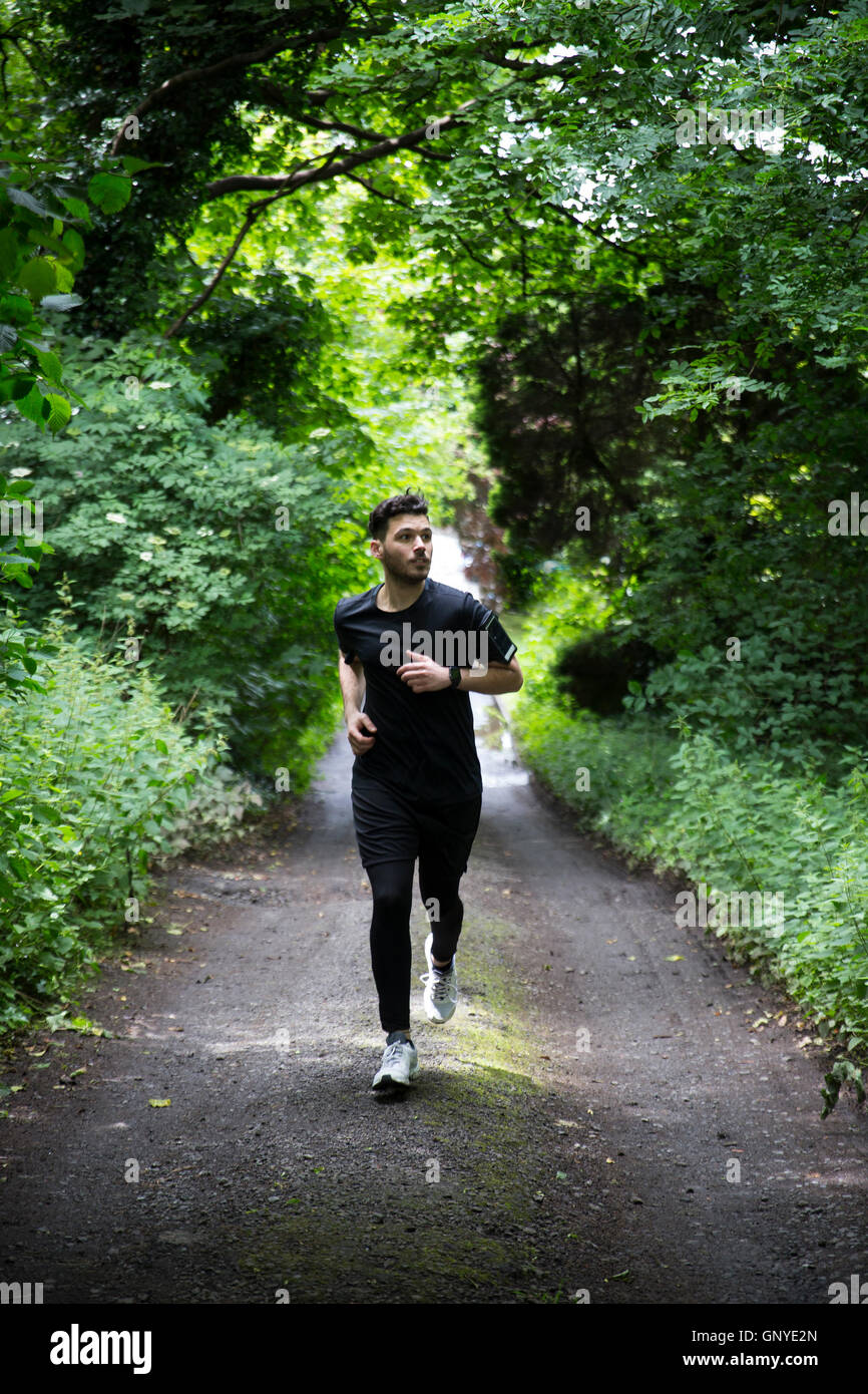 Young man running outdoors. Action and healthy lifestyle concept Stock ...