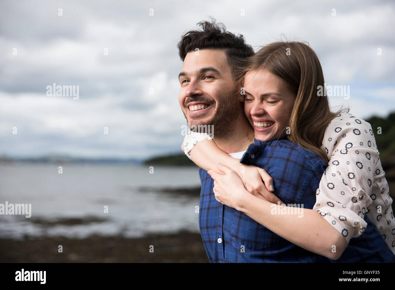 Romantic couple embracing walking along hi-res stock photography and ...