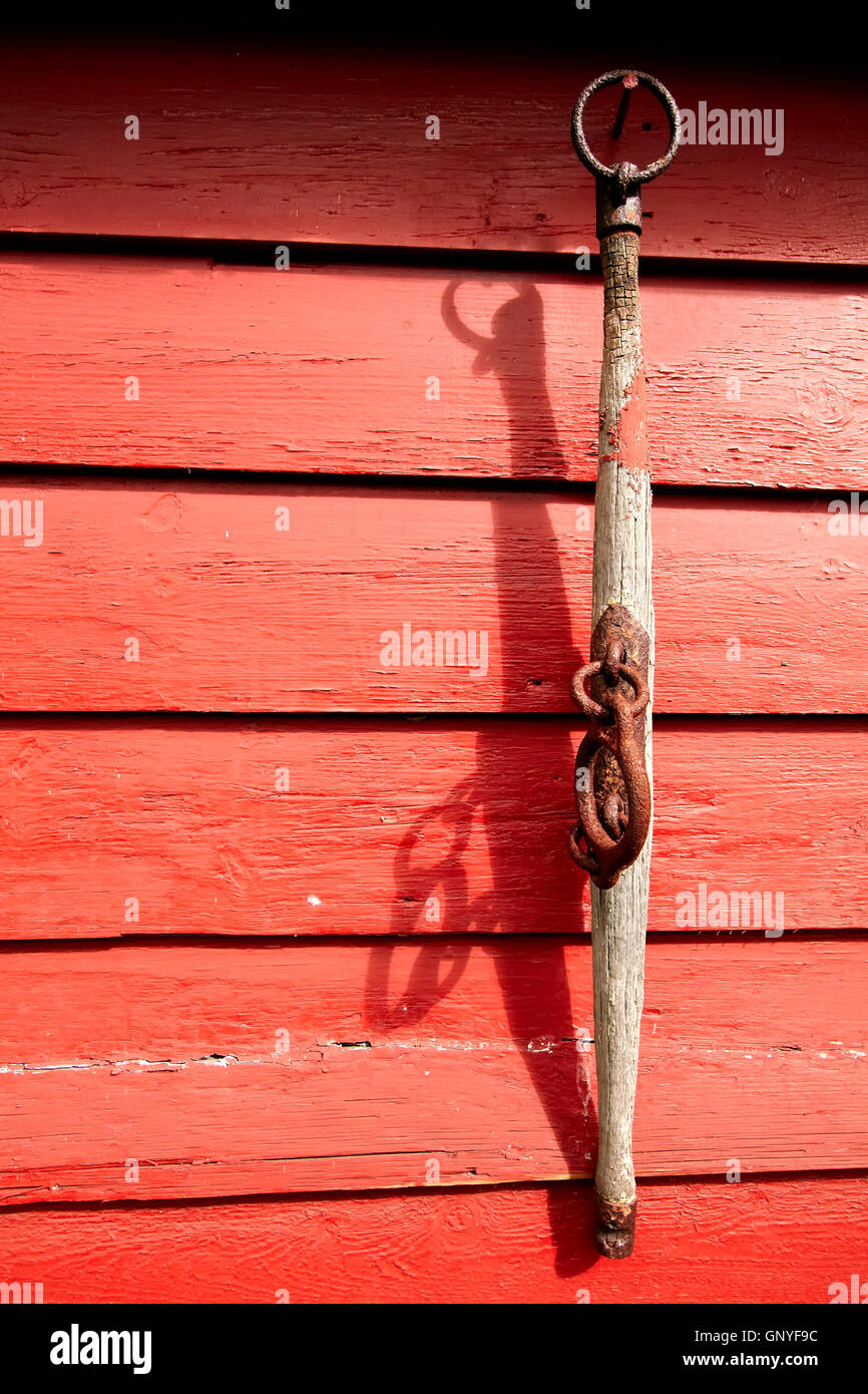 View of the agricultural tool hanging on a barn wall Stock Photo - Alamy