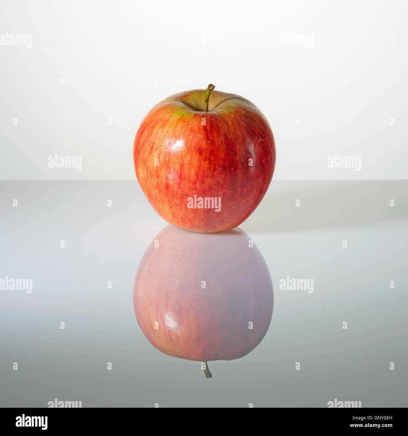 Red apple on a surface with reflection Stock Photo - Alamy