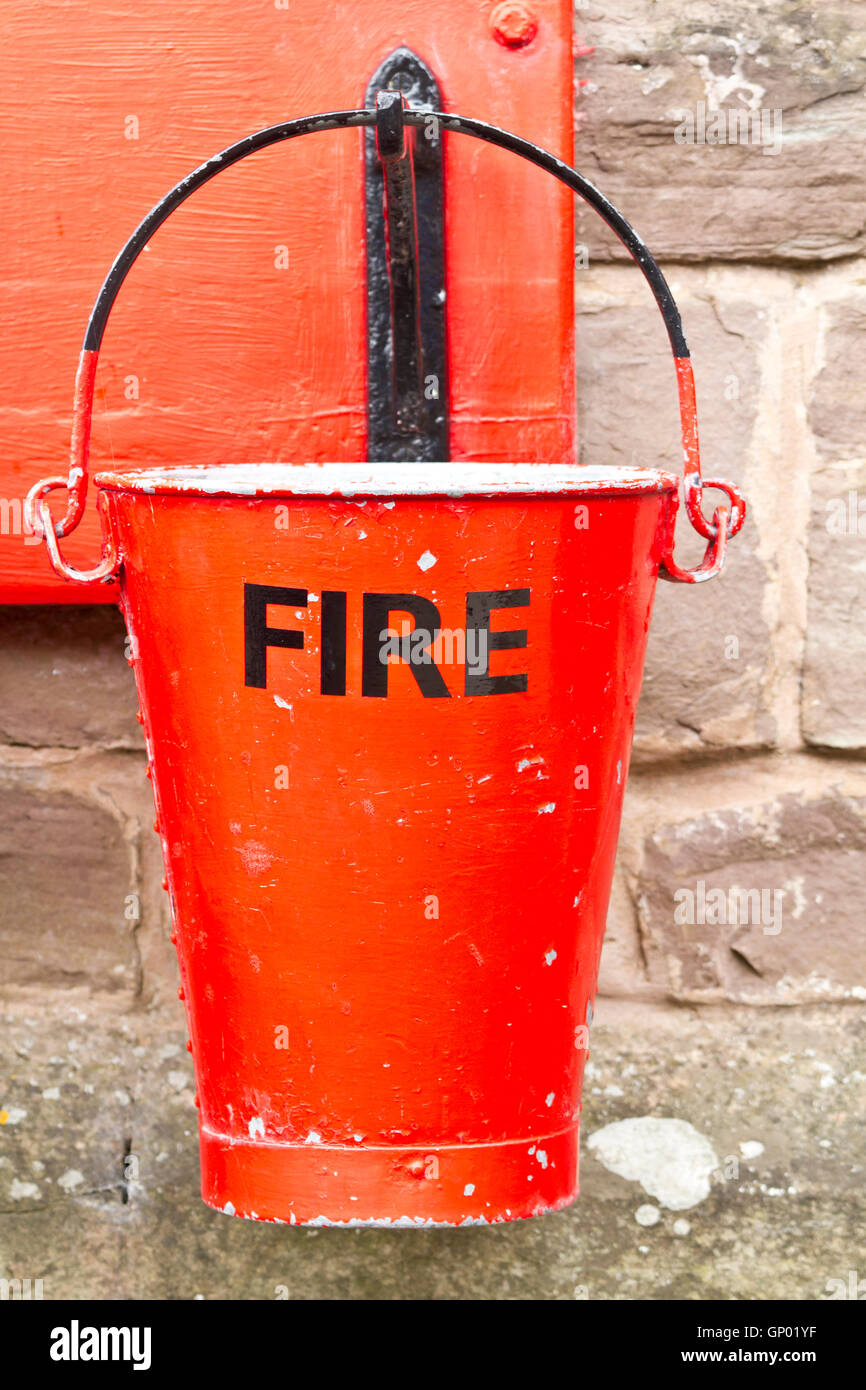 Single slightly battered fire bucket Stock Photo - Alamy