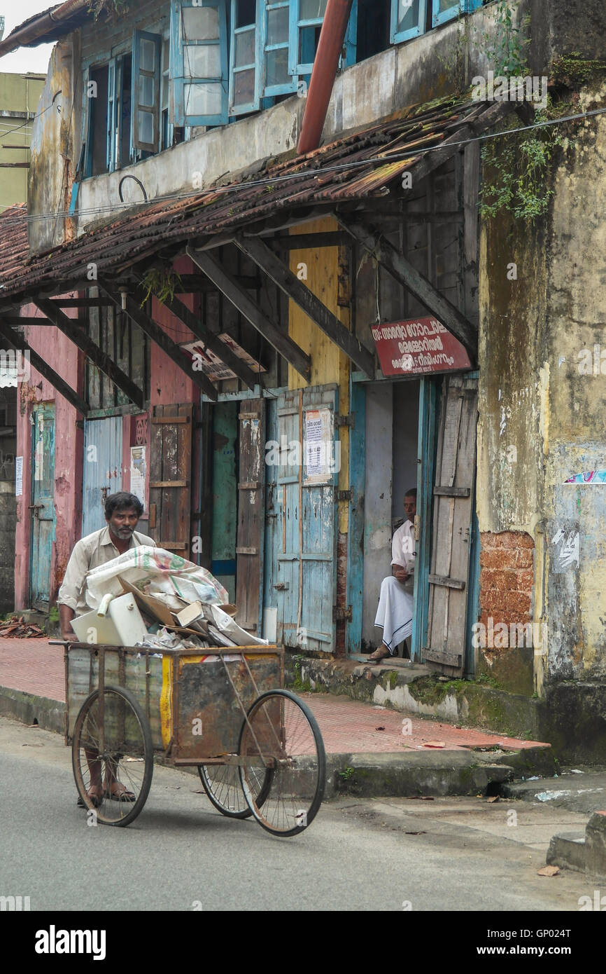 Man drive a loaded Rickshaw on a typical indian street in Fort Kochi ...