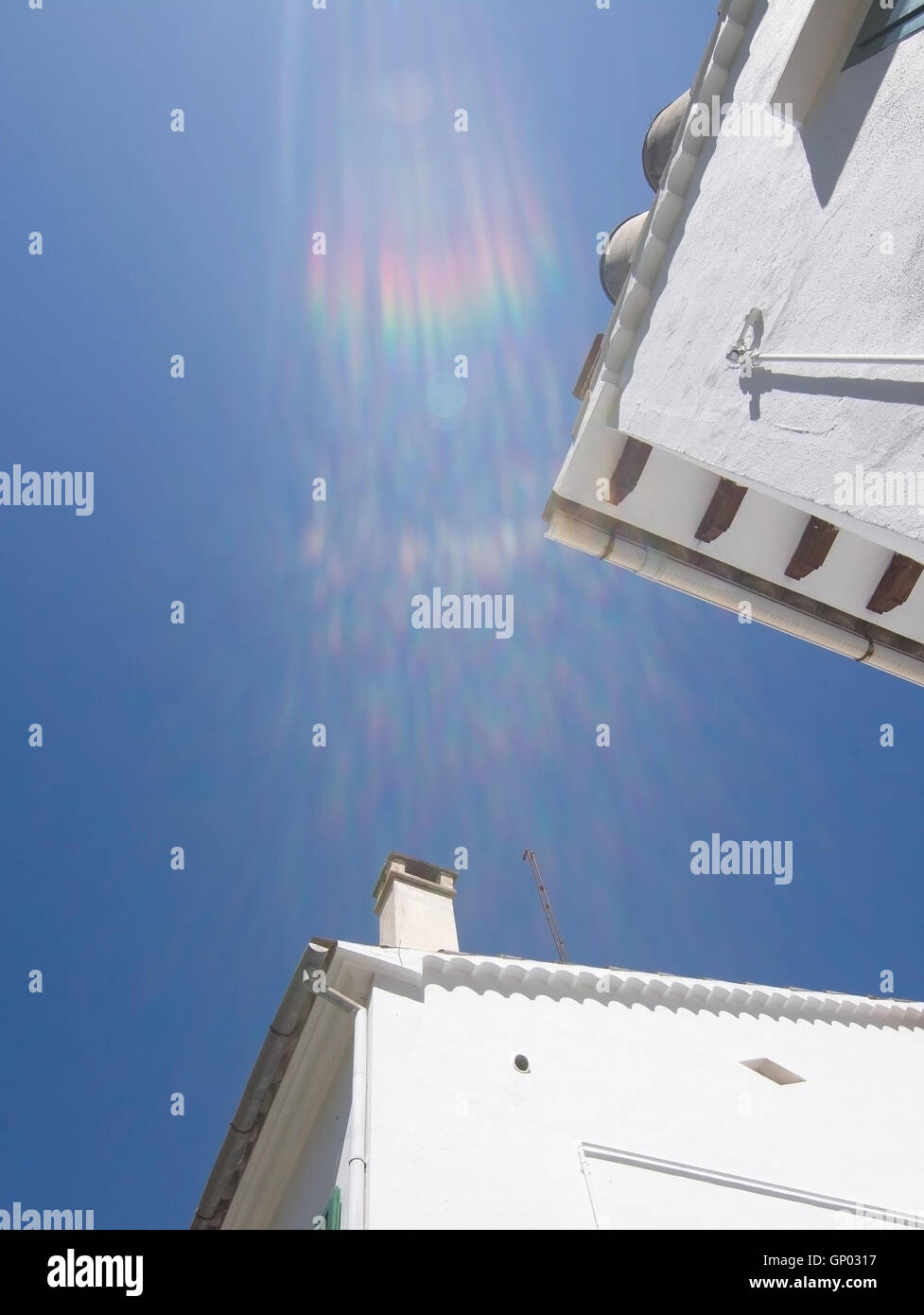 White Spanish traditional building roof and blue sky from below with ...