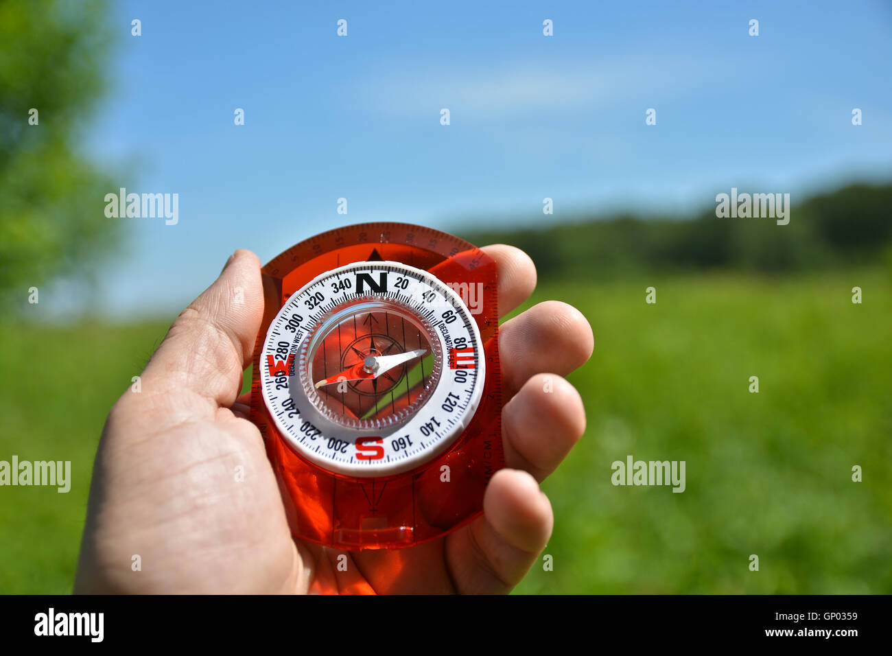 With the compass on a walk. Man's hand holds a magnetic compass Stock ...