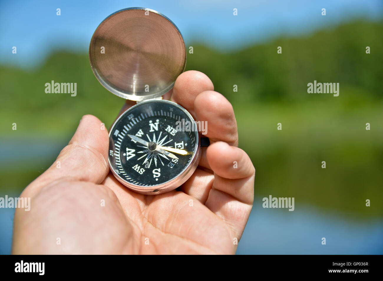 Magnetic compass in hand traveler. Tools to guide in the journey Stock ...