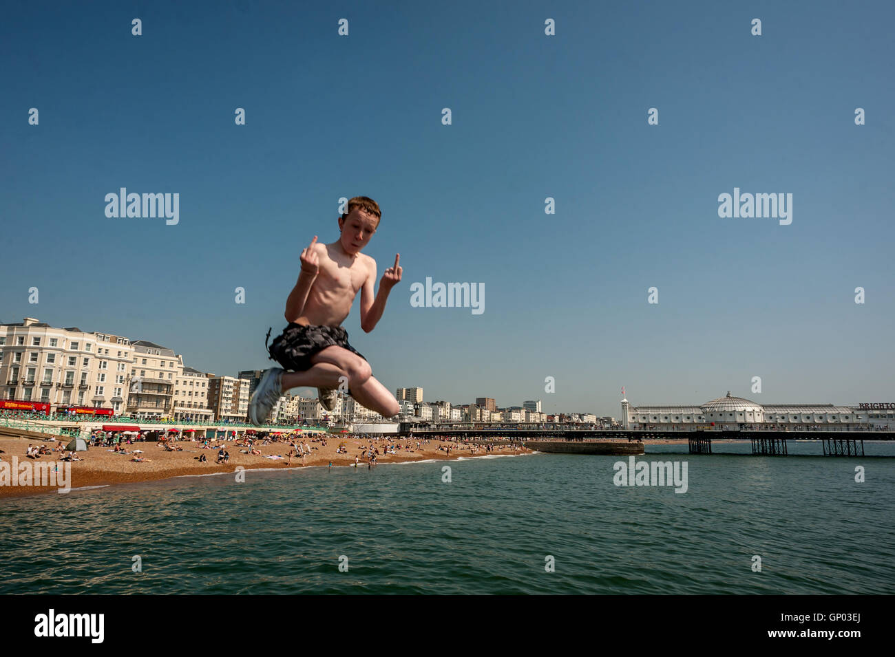 Young man jumping into the sea from the Banjo Groyne on the beach at ...