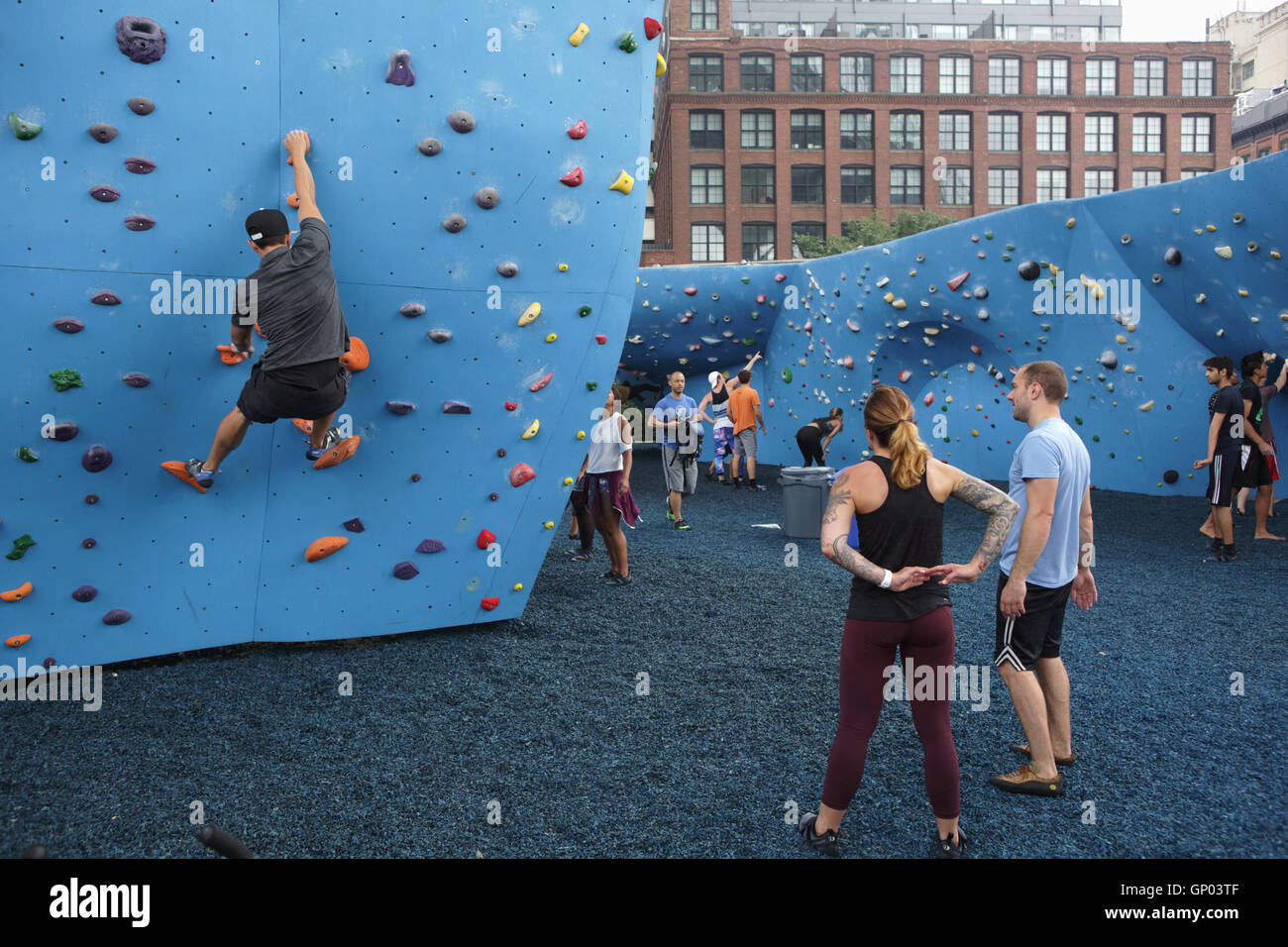 Climbing wall under the Manhattan Bridge in DUMBO, Brooklyn. Climbers ...