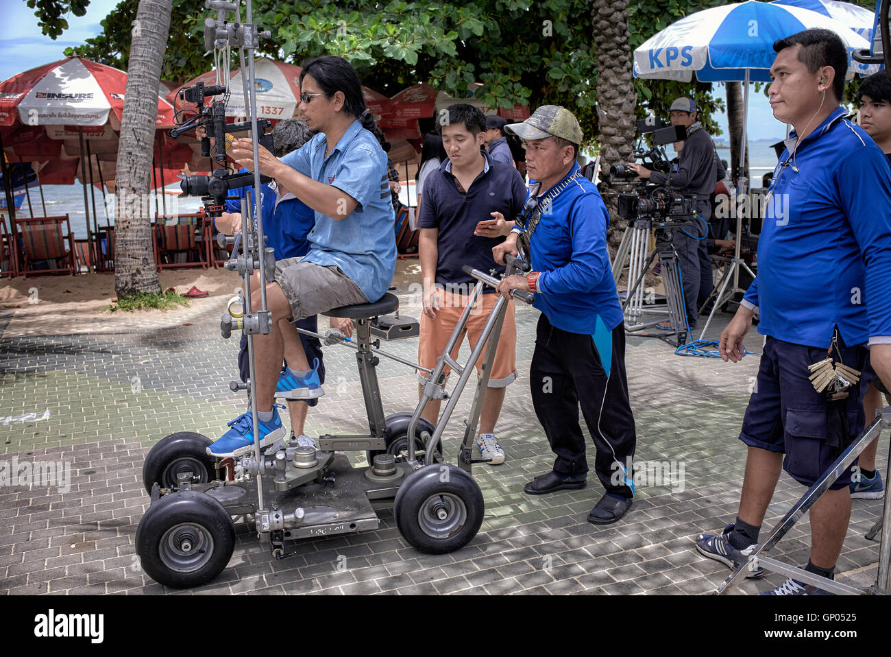 Film crew filming with mobile platform whilst shooting a street movie ...