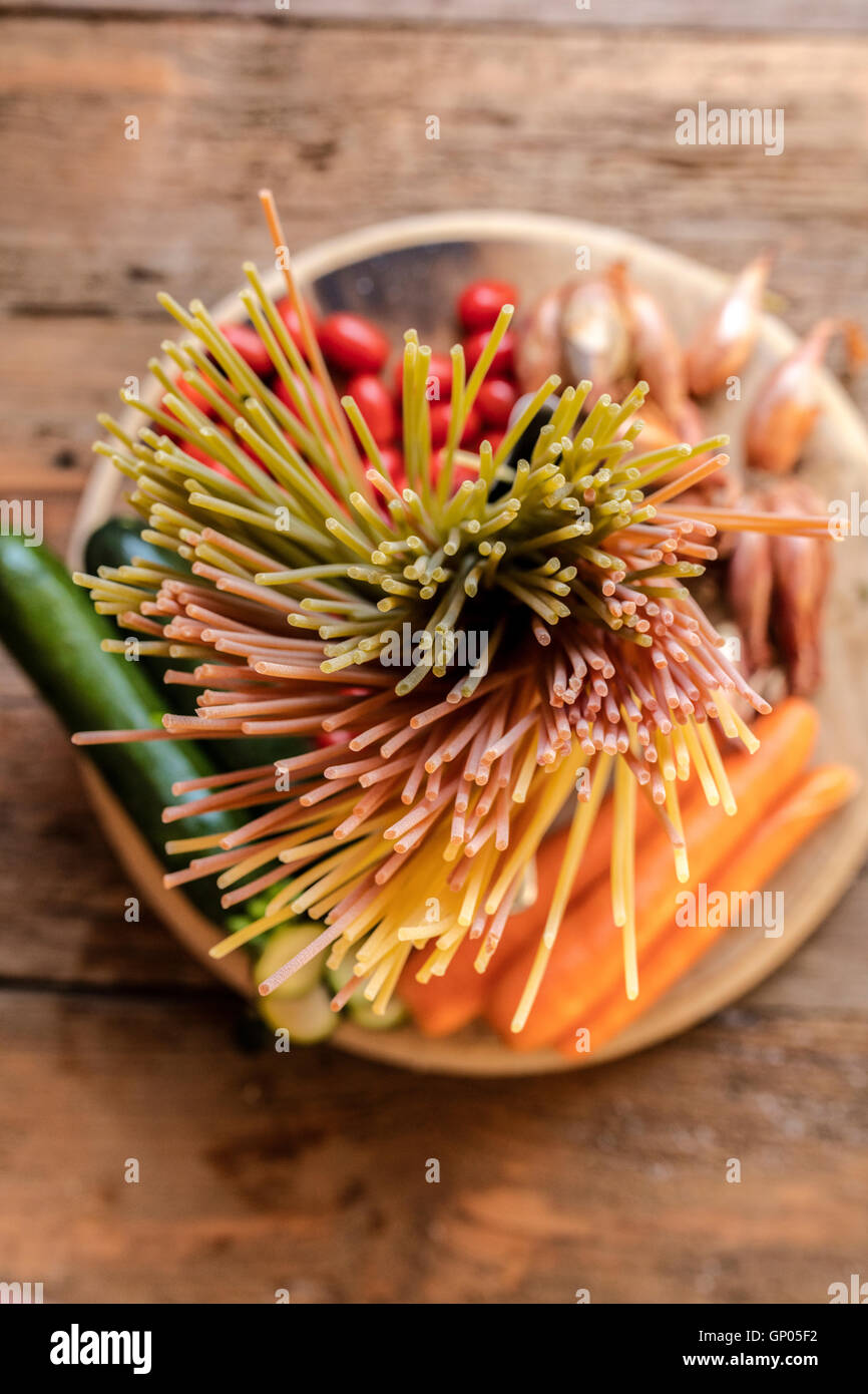 Italian colorful spaghetti and fresh vegetables as typical ingredients ...