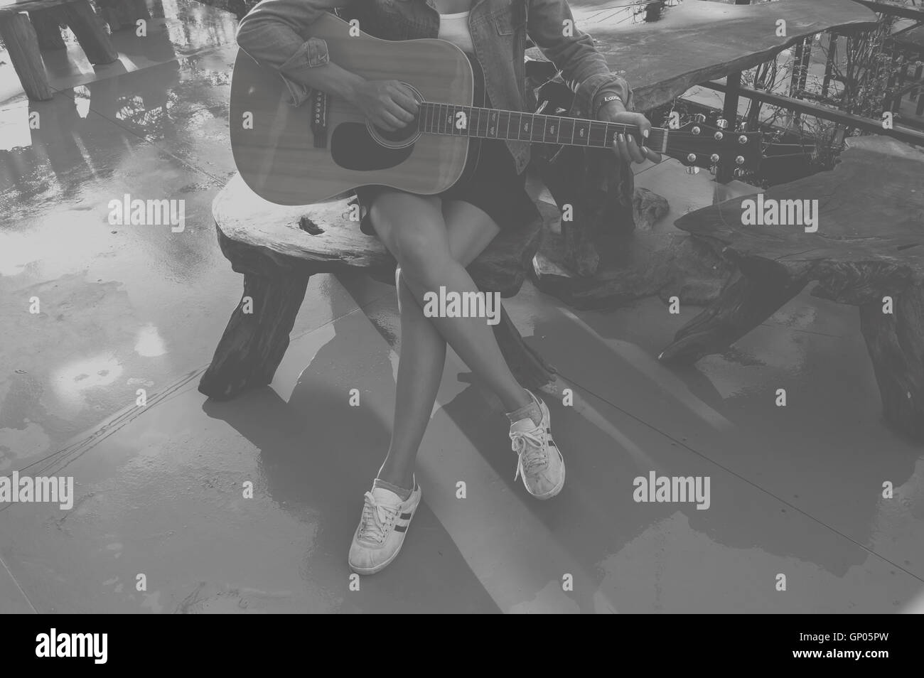 Asian woman playing guitar on wood table Stock Photo - Alamy