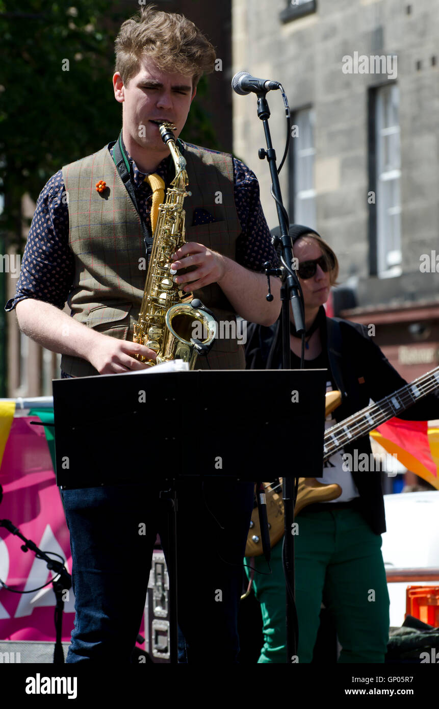 Saxophone player and bass guitarist taking part in the Mardi Gras, part ...