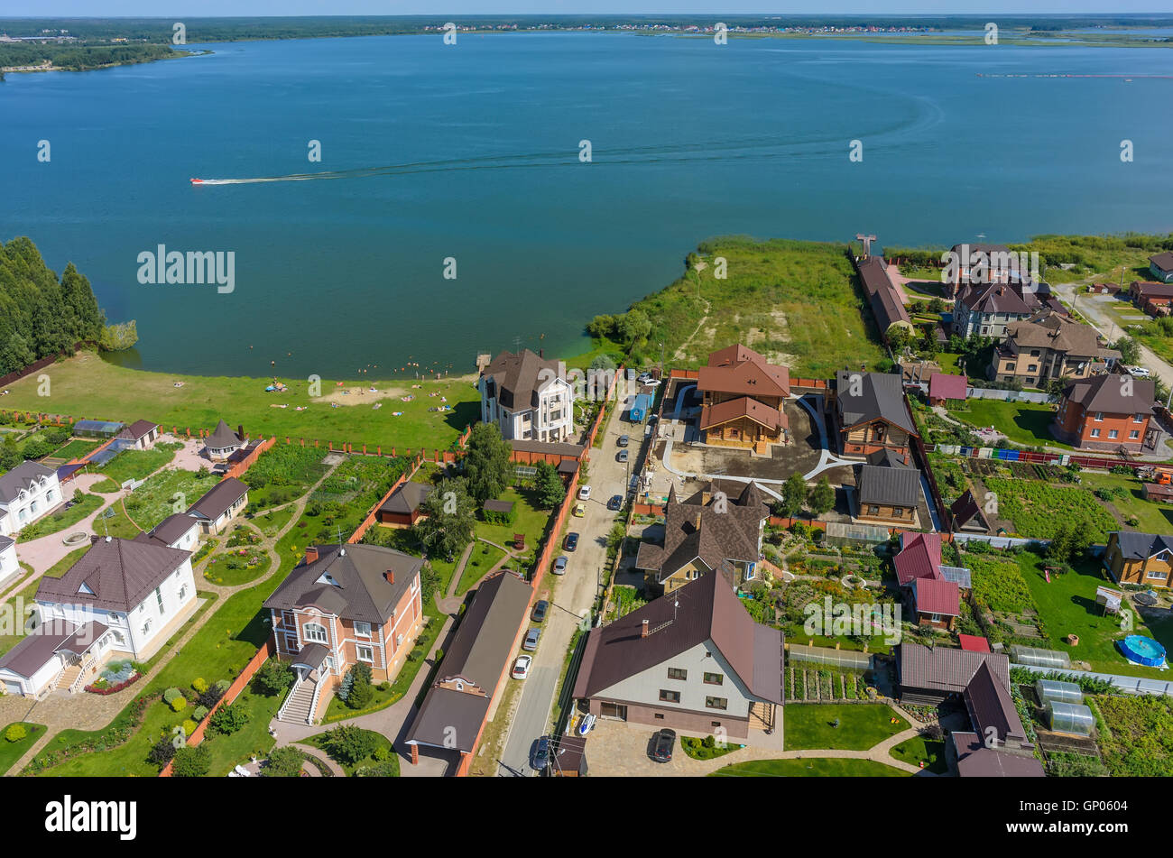 Village with beach on bank of lake. Borovskiy Stock Photo - Alamy