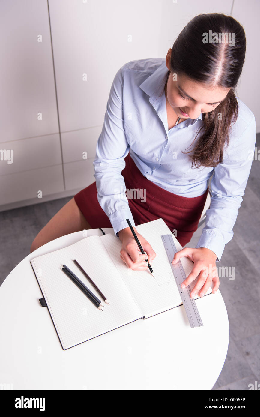 top view of young female engineer drawing into notebook Stock Photo - Alamy