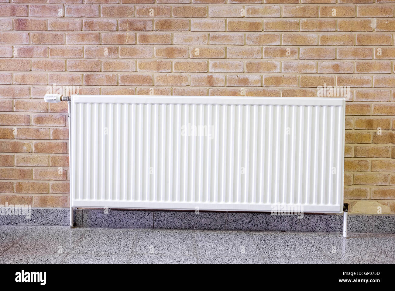 on concrete wall hang an radiator in working in the wall Stock Photo ...