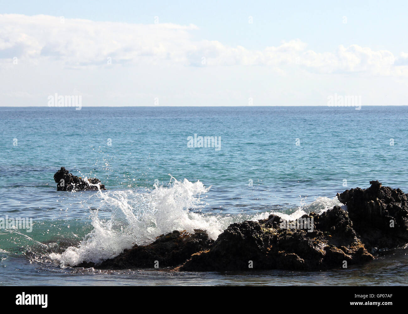 Waves Breaking Over Rocks In Ibiza Stock Photo - Alamy
