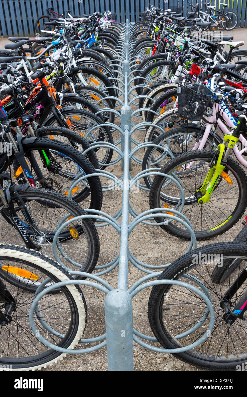 Cycles in a rack at a bike park at Ry in Denmark Stock Photo - Alamy