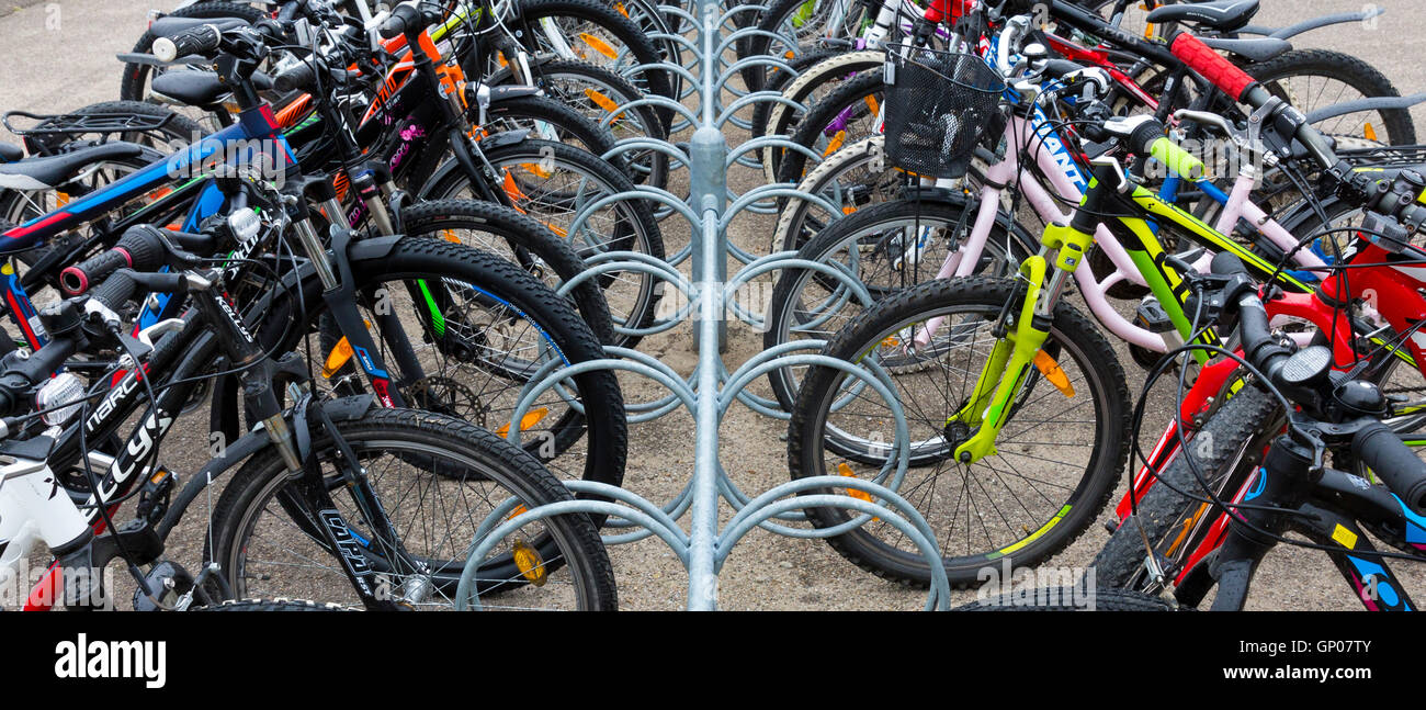 Cycles in a rack at a bike park at Ry in Denmark Stock Photo - Alamy