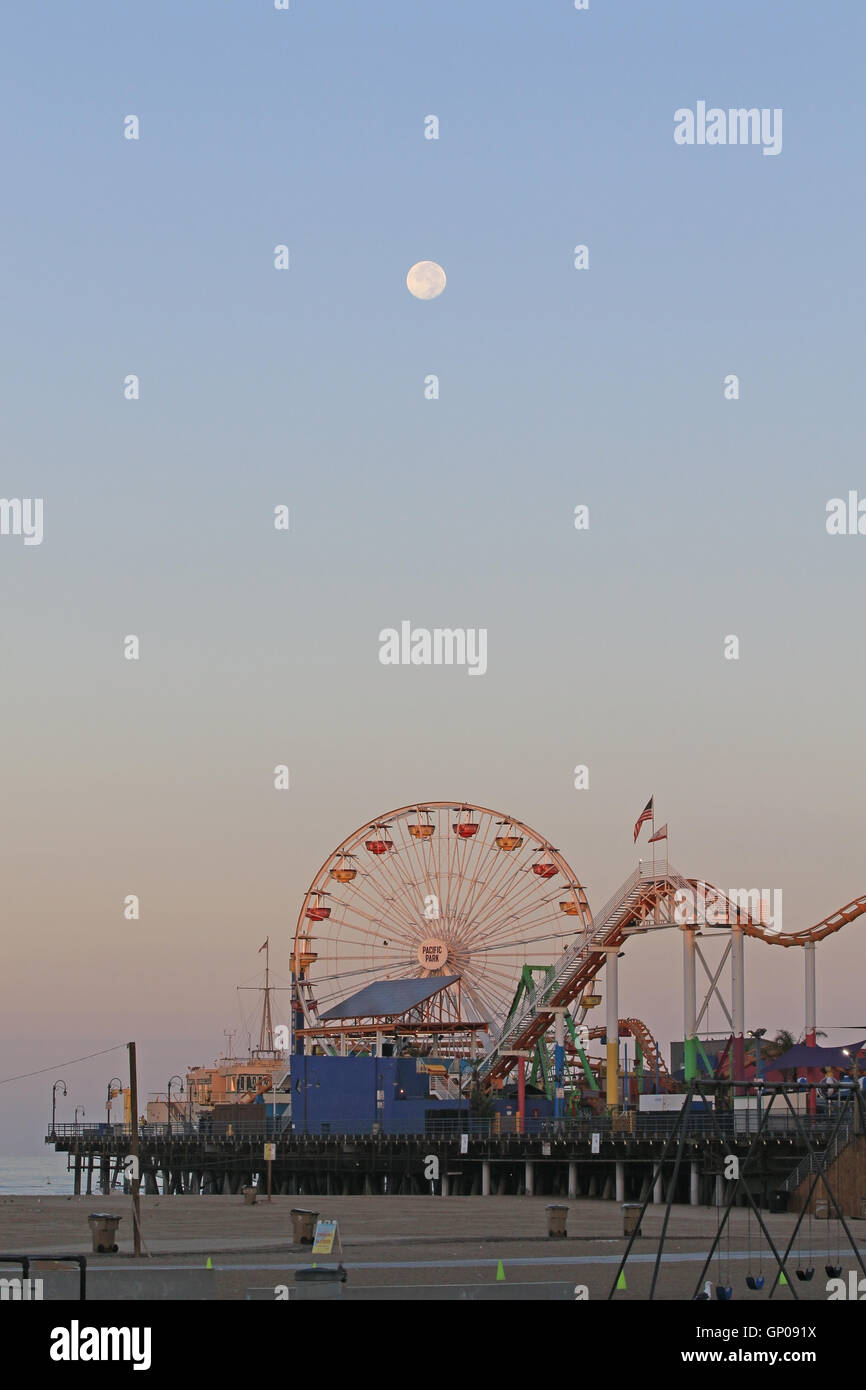 Beach pier sunrise with full moon in the background Stock Photo - Alamy