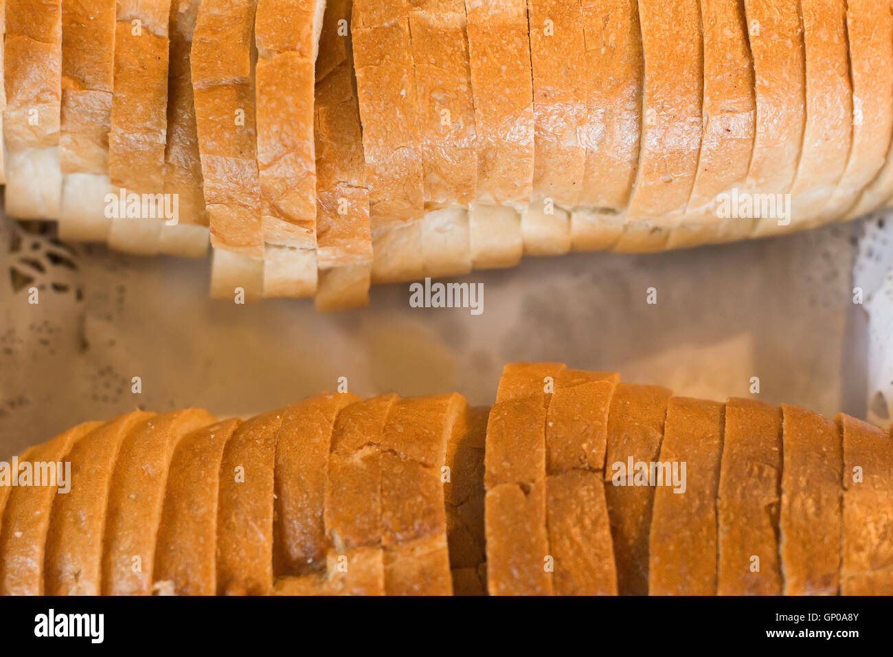 Sliced loaf of breads in basket, top view, close up. Shallow depth of ...