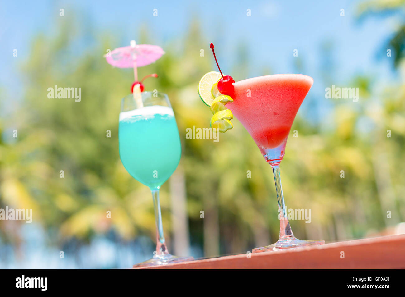 Cocktail glasses at pool, beach side Stock Photo - Alamy