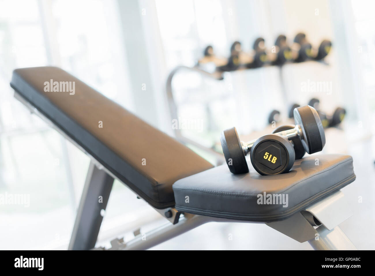 Two dumbbells on the exercise bench. Gym equipment Stock Photo - Alamy