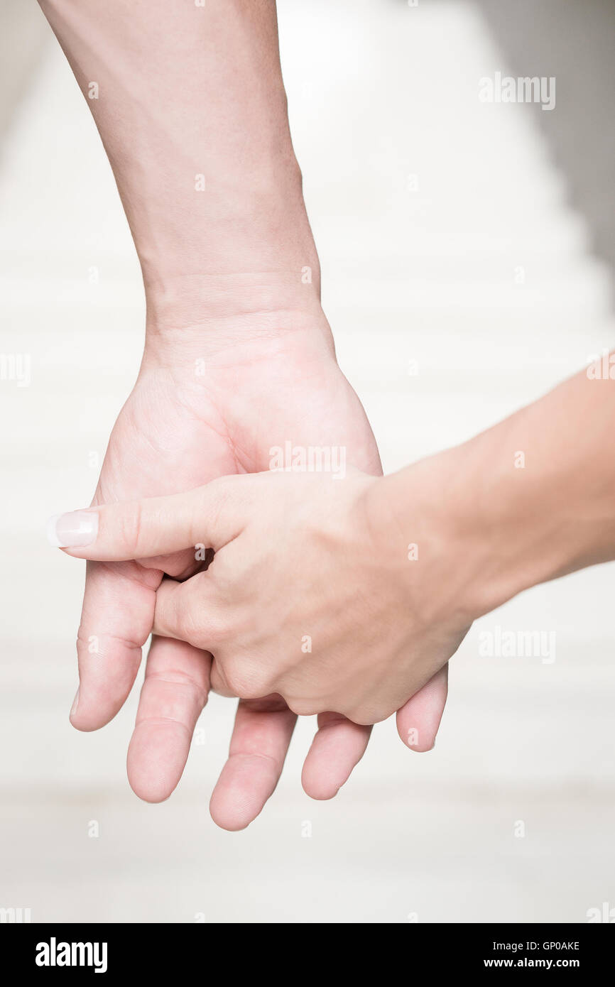 Two hands holding together hi-res stock photography and images - Alamy