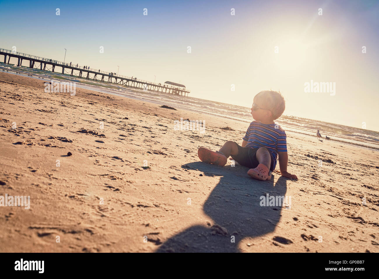 Boy sitting on the beach, South Australia Stock Photo - Alamy