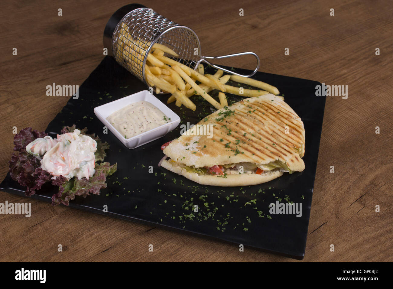 Greek pita gyro with potato fries and sauce Stock Photo - Alamy