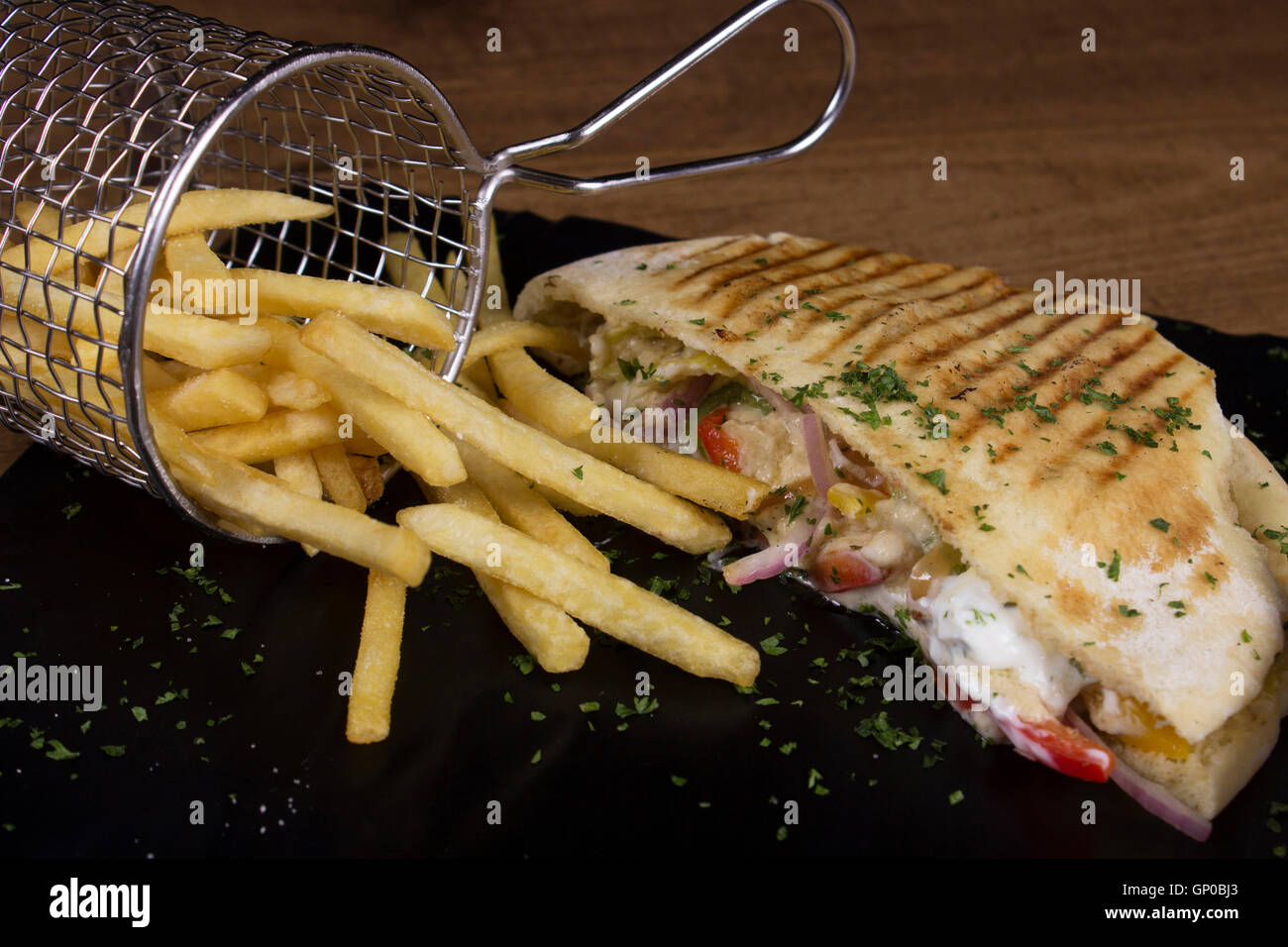 Greek pita gyro with potato fries Stock Photo - Alamy