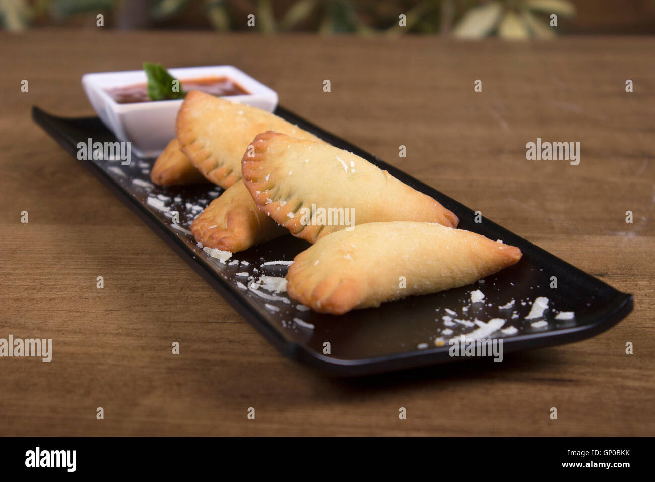 Mini panzerotti with sauce. Small versions of calzoni that are usually ...