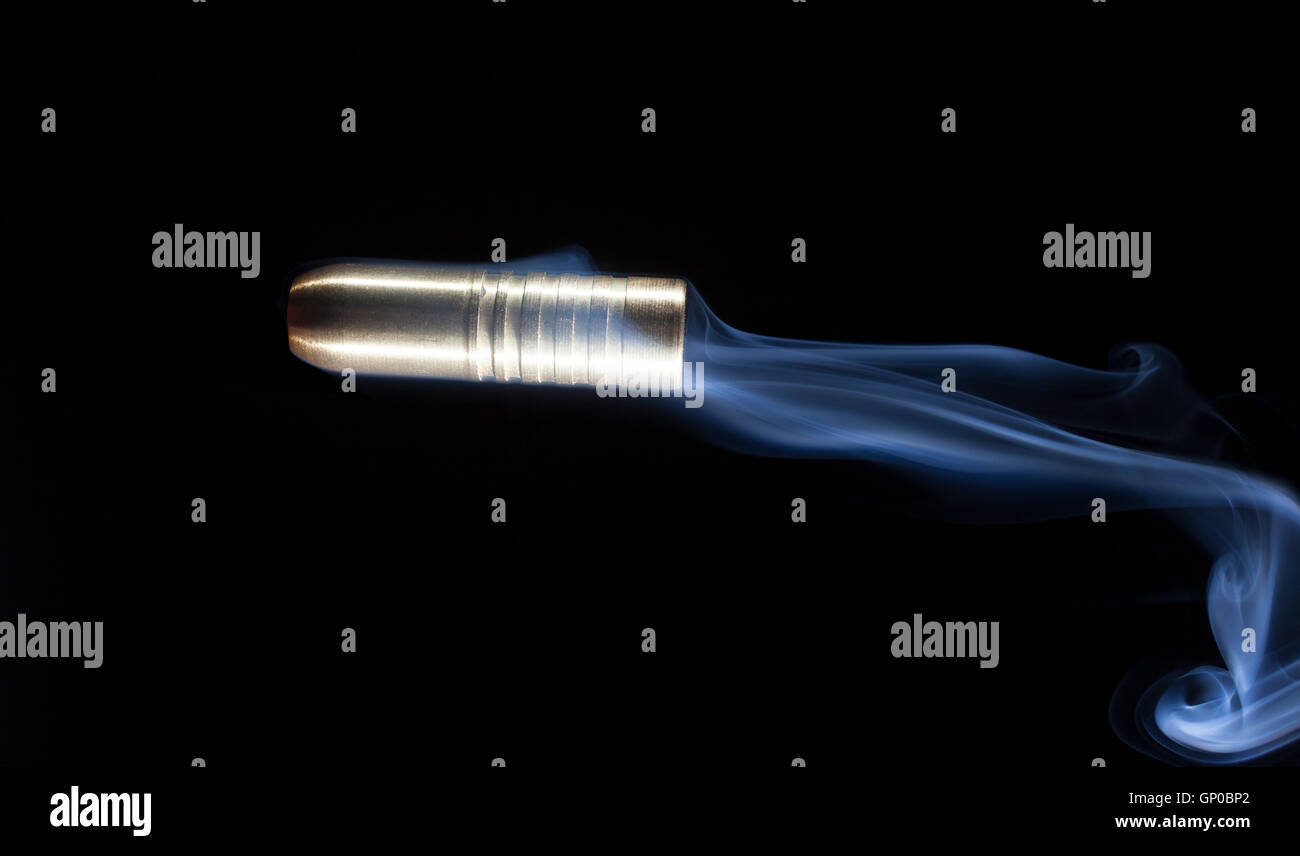 Brass colored bullet that looks like it is going by with smoke Stock ...