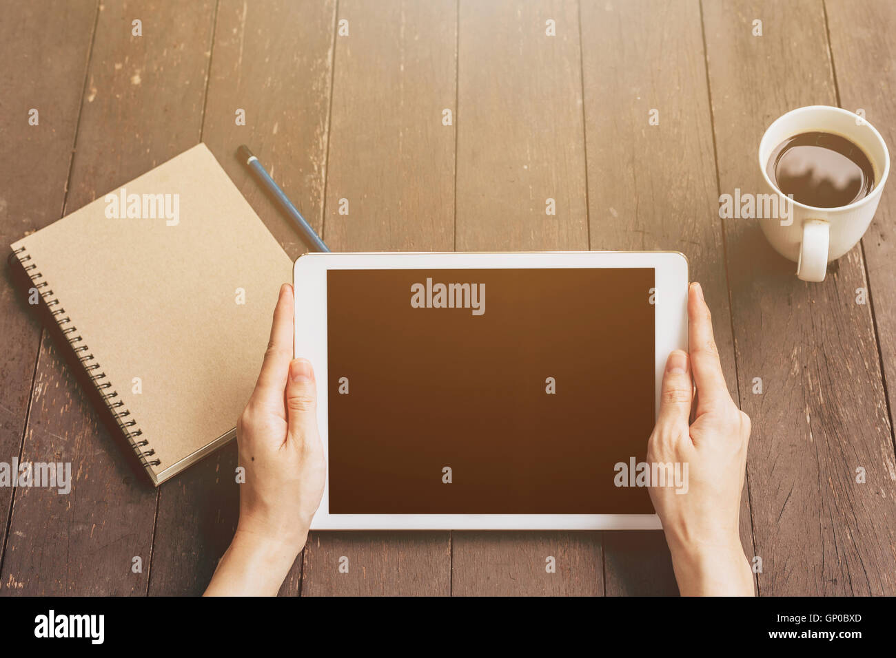 Using tablet hand table hi-res stock photography and images - Alamy
